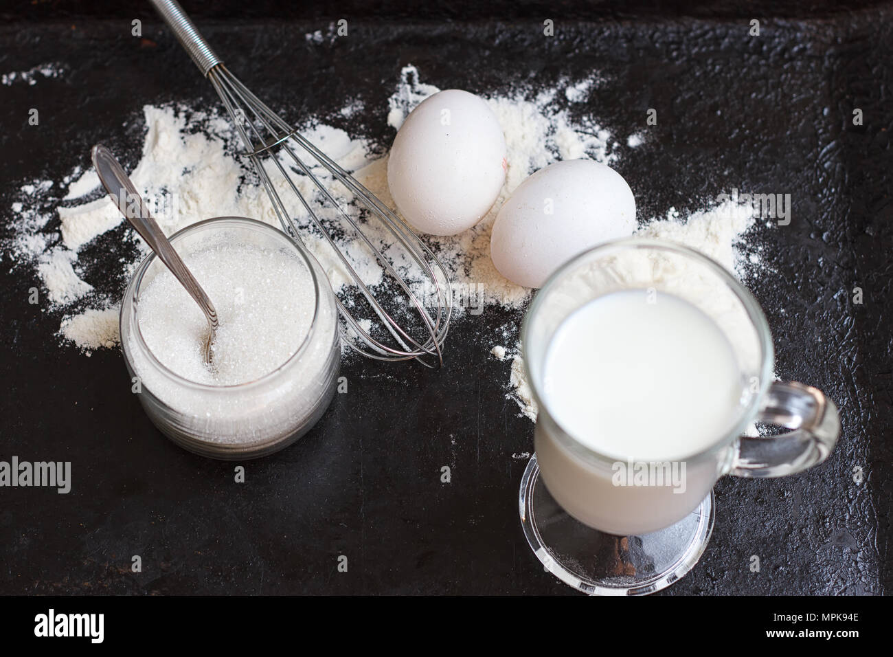 Ingredients for a cake on a black natural stone Stock Photo - Alamy