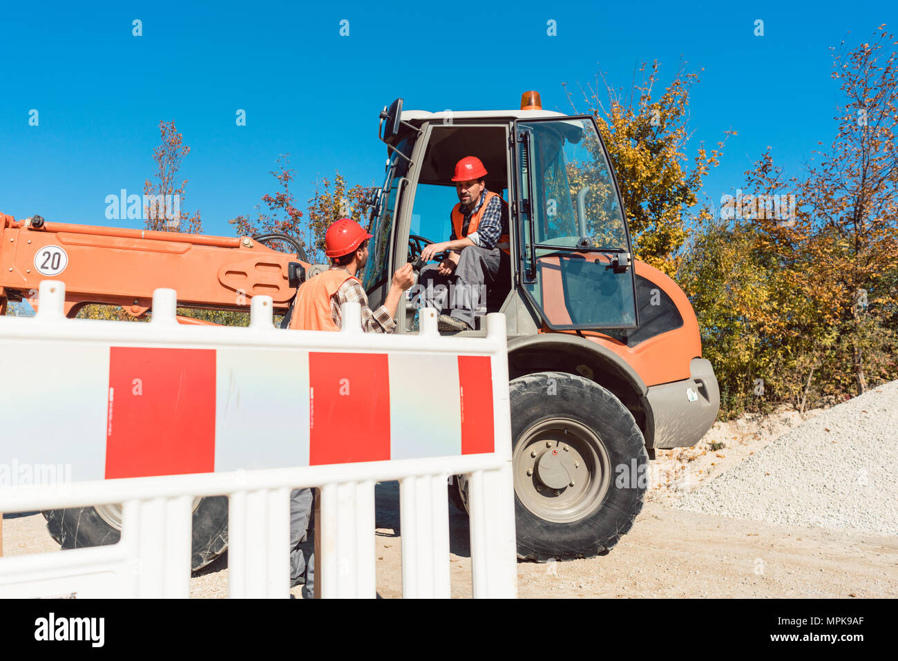 Construction worker starting road works on site Stock Photo - Alamy