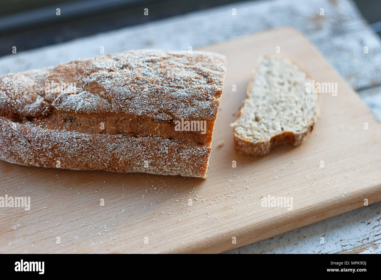 Sliced homemade bread on wooden cutting board with vintage knife hi-res ...