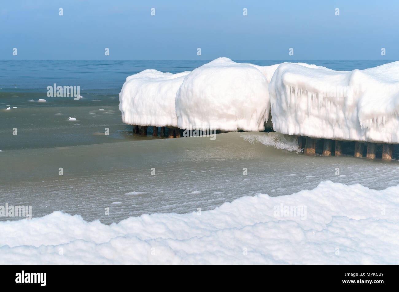 sea waves in the icy snow slush, ice on breakwaters in the sea, sea ...