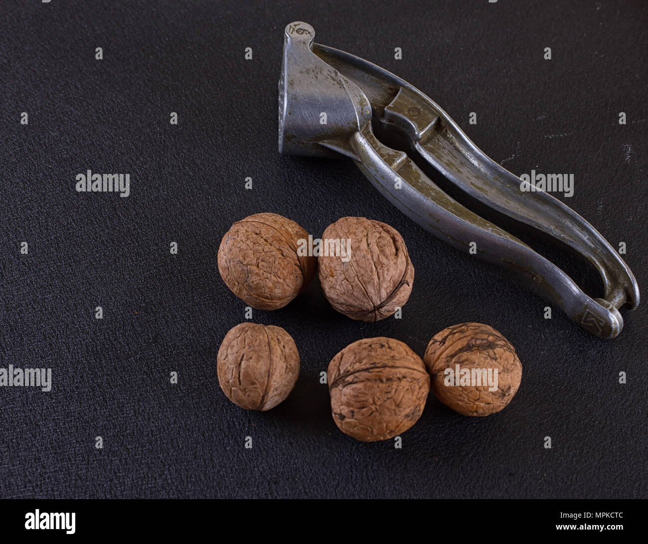 Greek nuts whole and split and the Nutcracker Stock Photo - Alamy