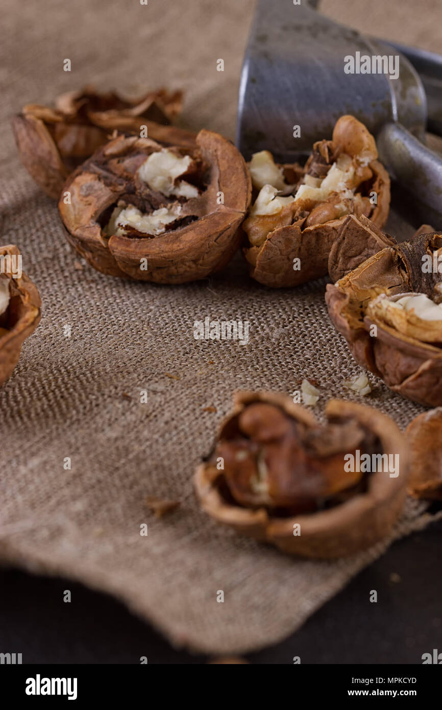 walnuts and a nutcracker on a table covered with burlap Stock Photo - Alamy