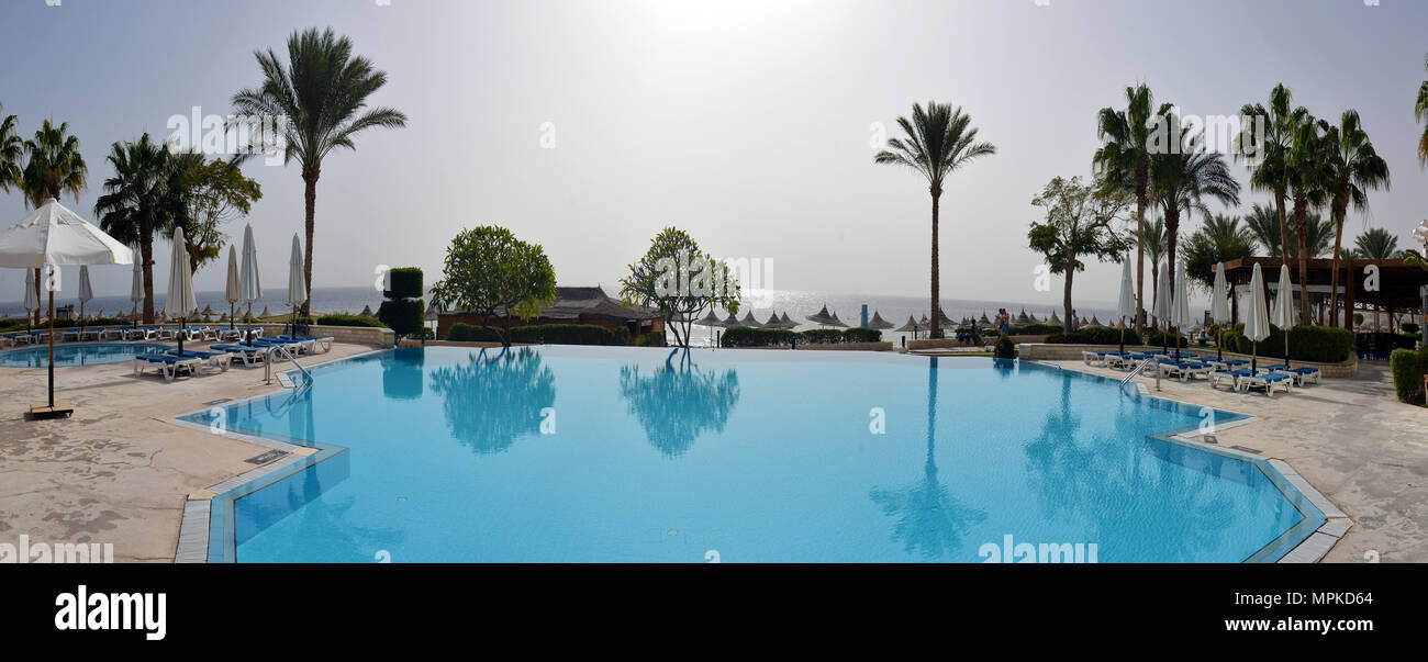 Swimming pool with sun beds at the hotel Stock Photo - Alamy