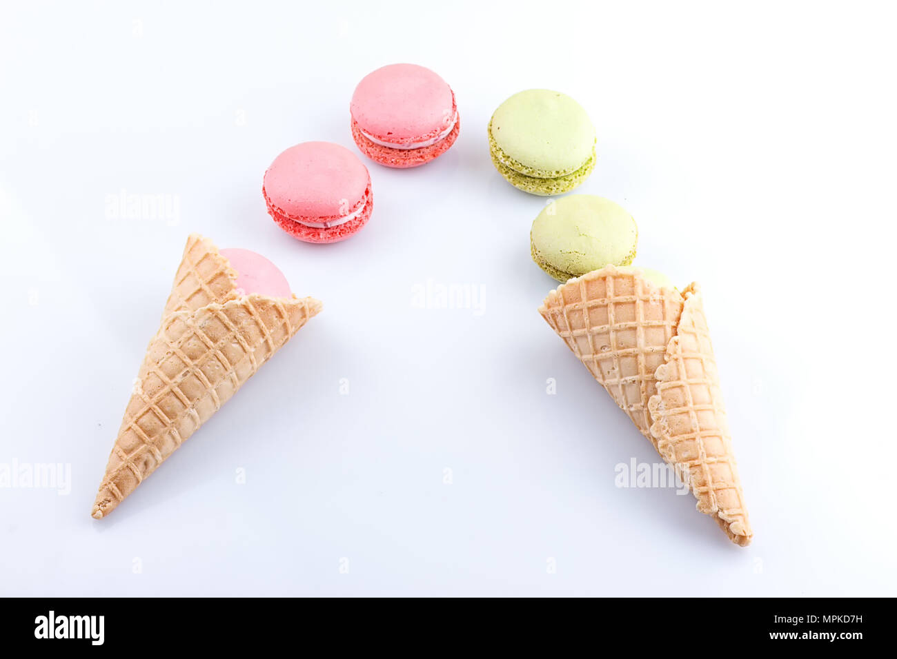 Colorful macaron pink color in ice cream cone of waffle on white ...