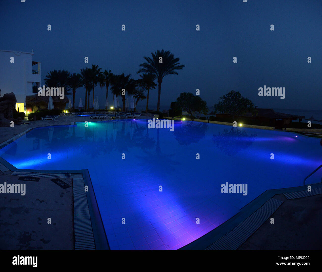 Pool illuminated at night in the hotel Stock Photo - Alamy