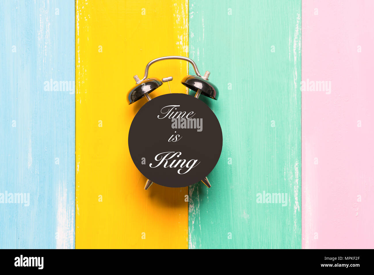 time is king black alarm clock on the colorful backgrounds with wording ...