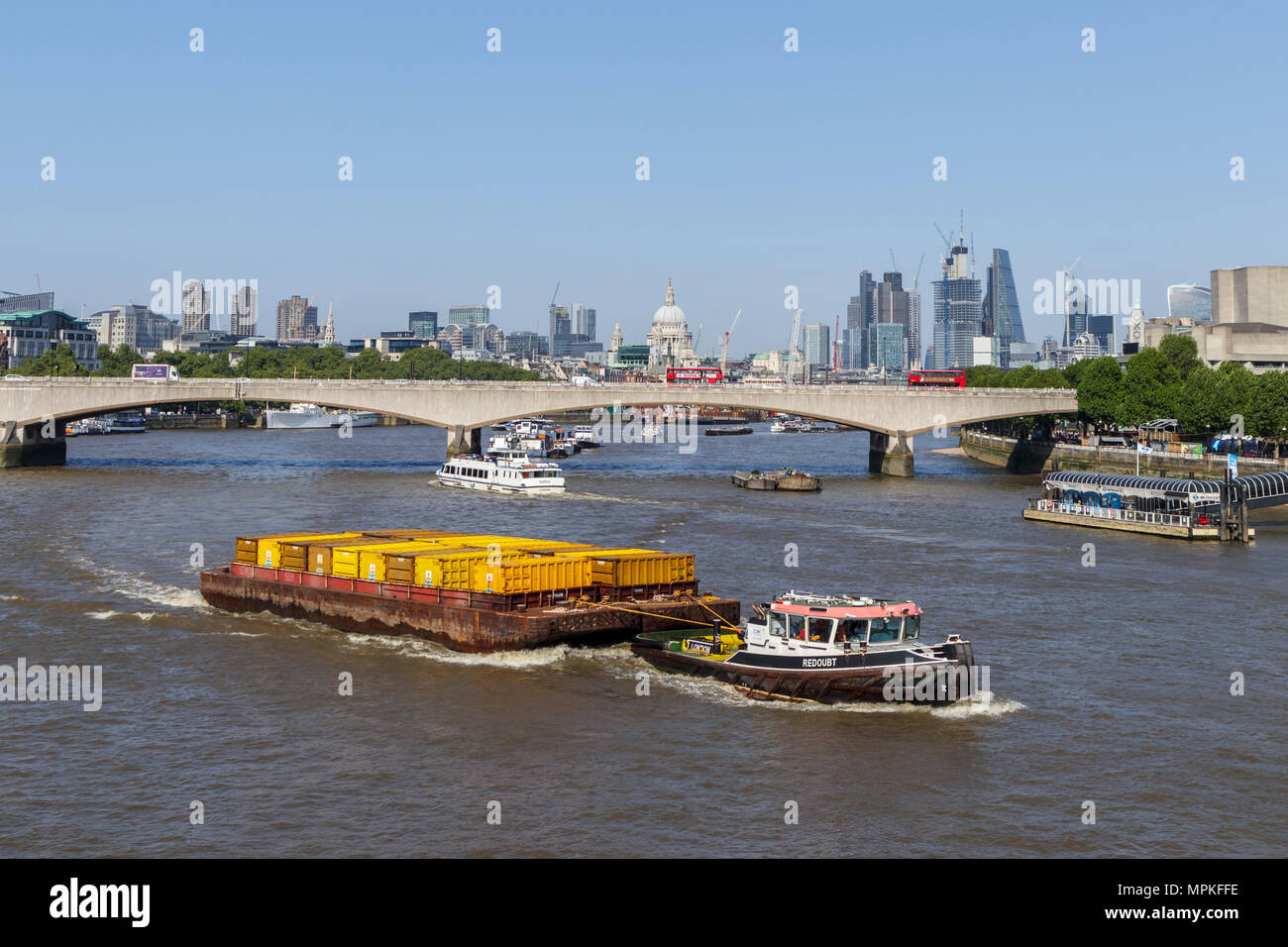 Cory Riverside tug 'Redoubt' towing a barge loaded with yellow ...