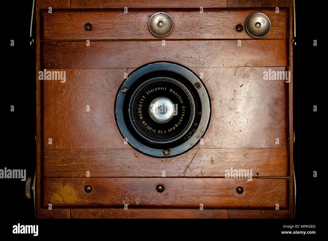 Frontal vintage rare wooden camera projecting light from the inside ...