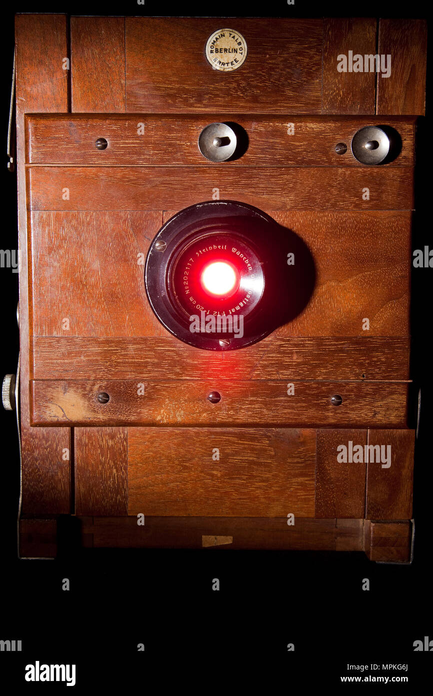 Frontal vintage rare wooden camera projecting light from the inside ...
