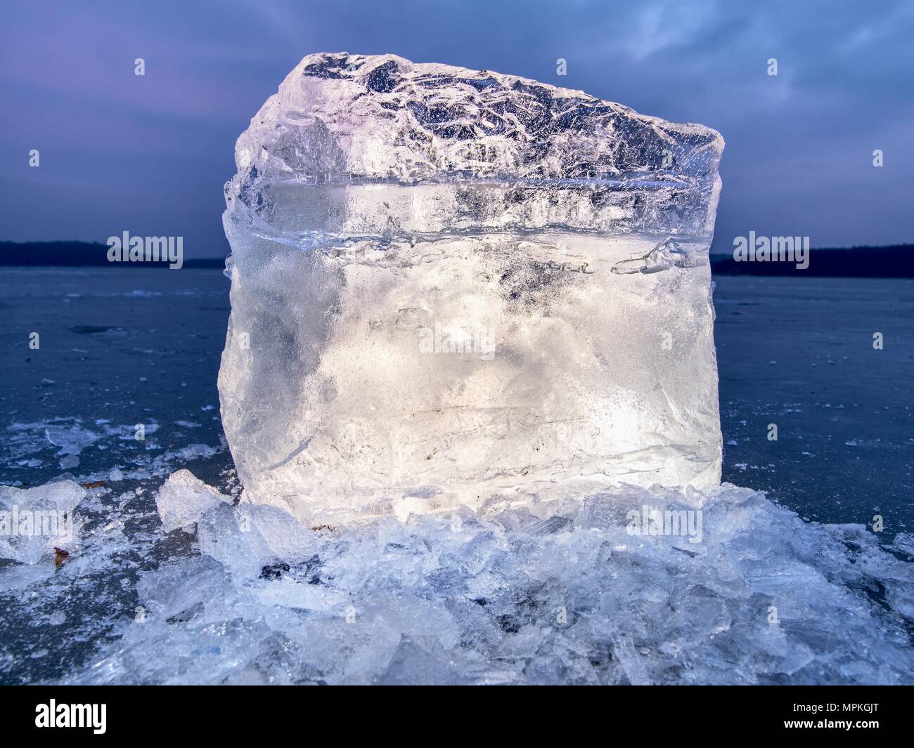 Arctic ice. A large piece of natural ice on a green blue flat ice of ...
