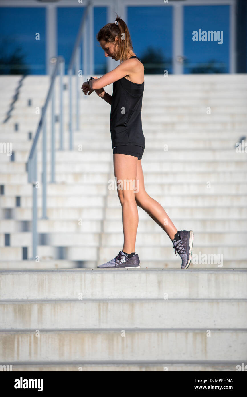 Female marathon runner checking smart watch hi-res stock photography ...