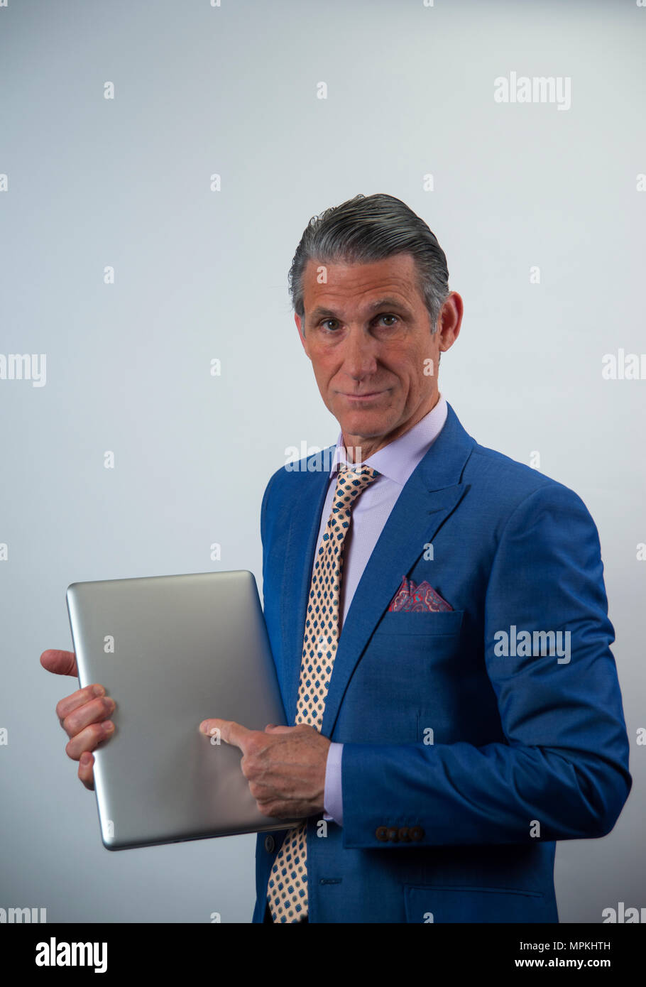 Elegant executive carrying a portable computer Stock Photo - Alamy