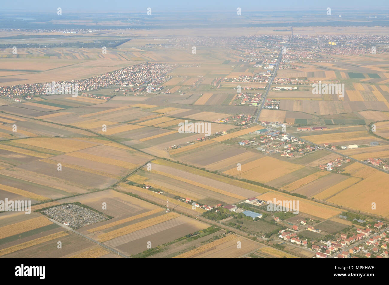 Plains with different plants and a city suburb seen from the air ...
