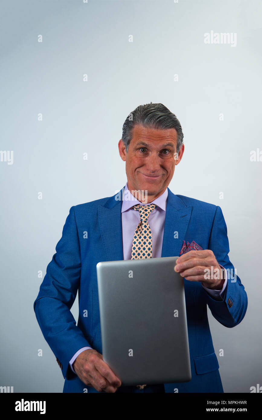 Elegant executive carrying a portable computer Stock Photo - Alamy