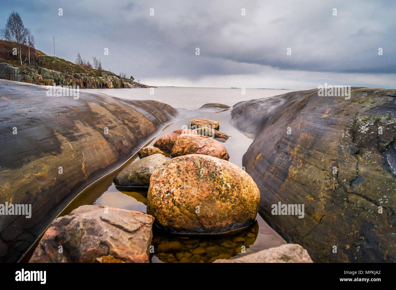Rocks and sea on a cloudy day in Helsinki in Finland Stock Photo - Alamy