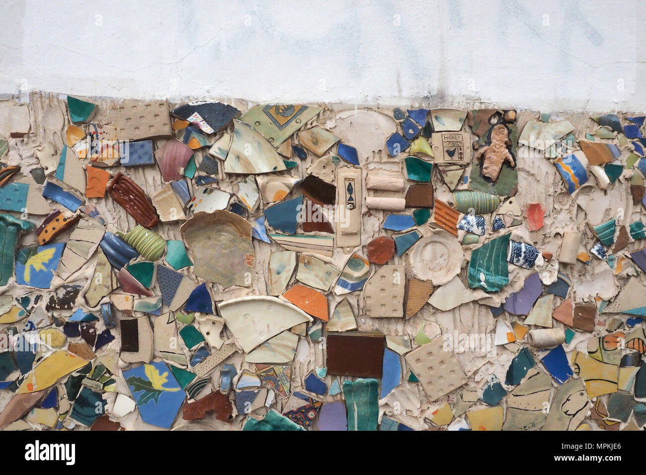 Small angular fragments of broken glass are orange, blue, brown, yellow ...