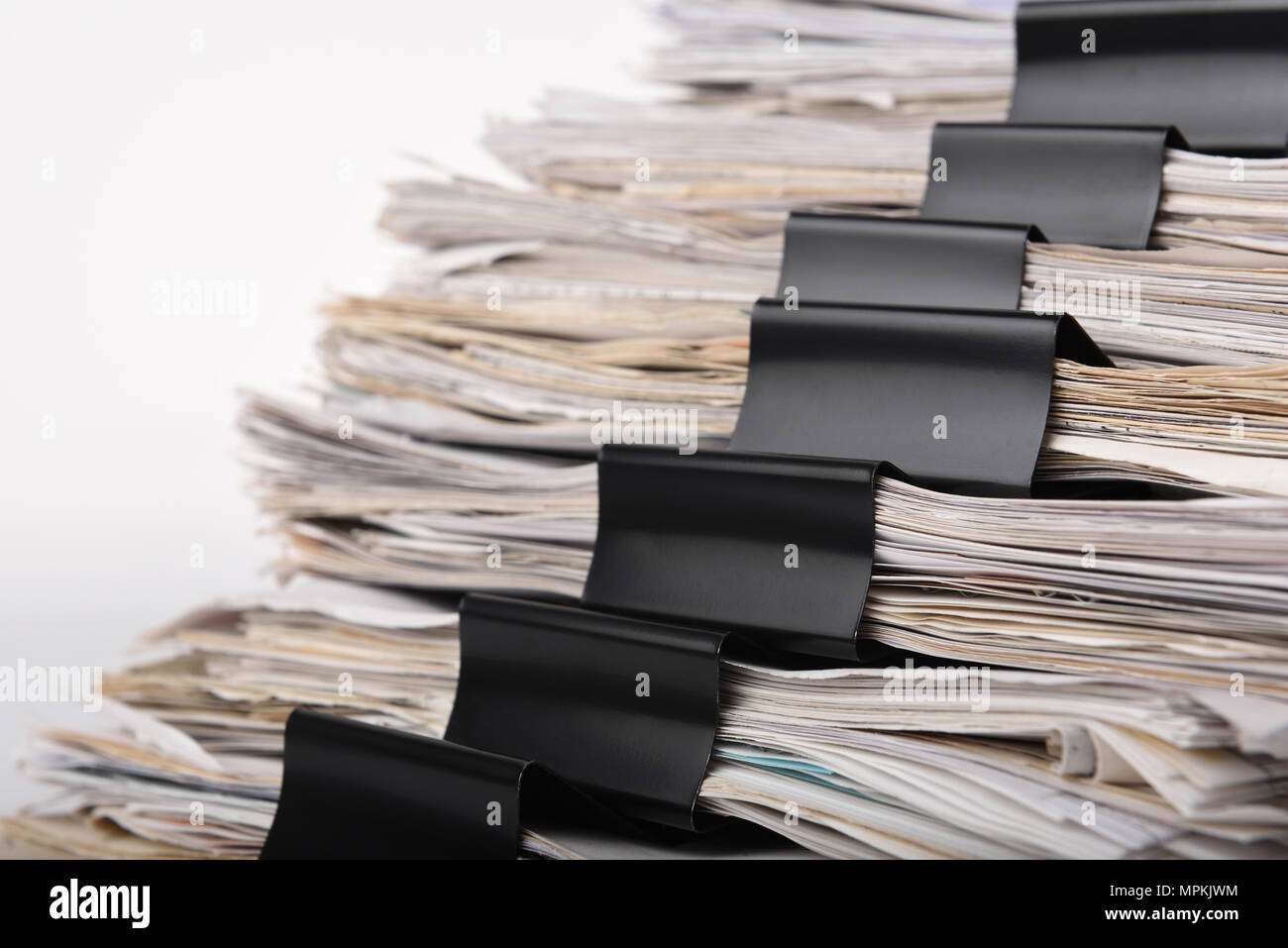 Paper stack storage and Black Paper Clip pace on white isolated ...