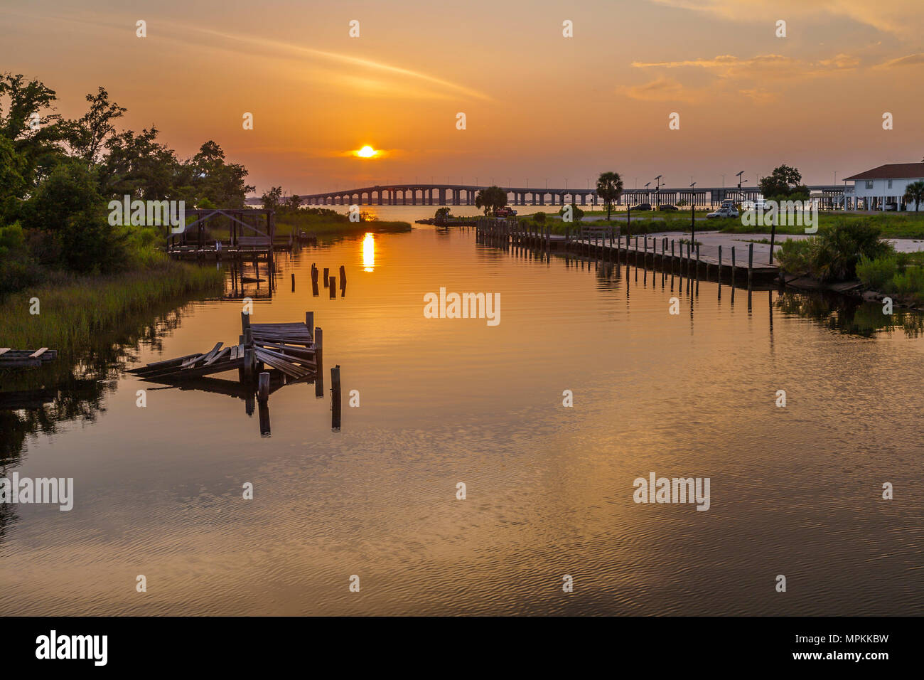 St. Louis Bay Bridge behind the remains of an old wooden dock in a ...