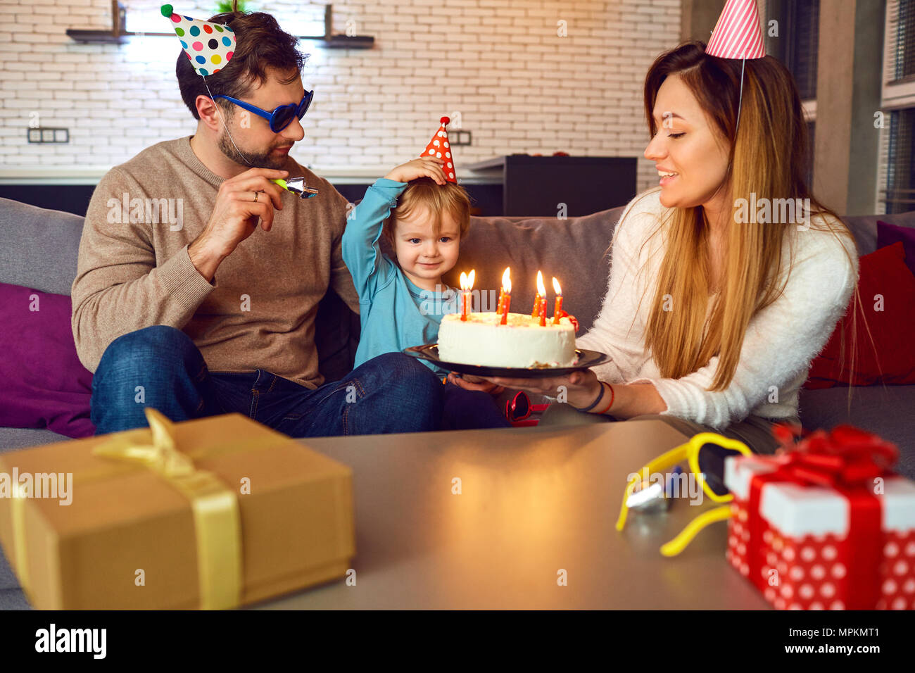 Parents with birthday cake congratulate their child Stock Photo - Alamy