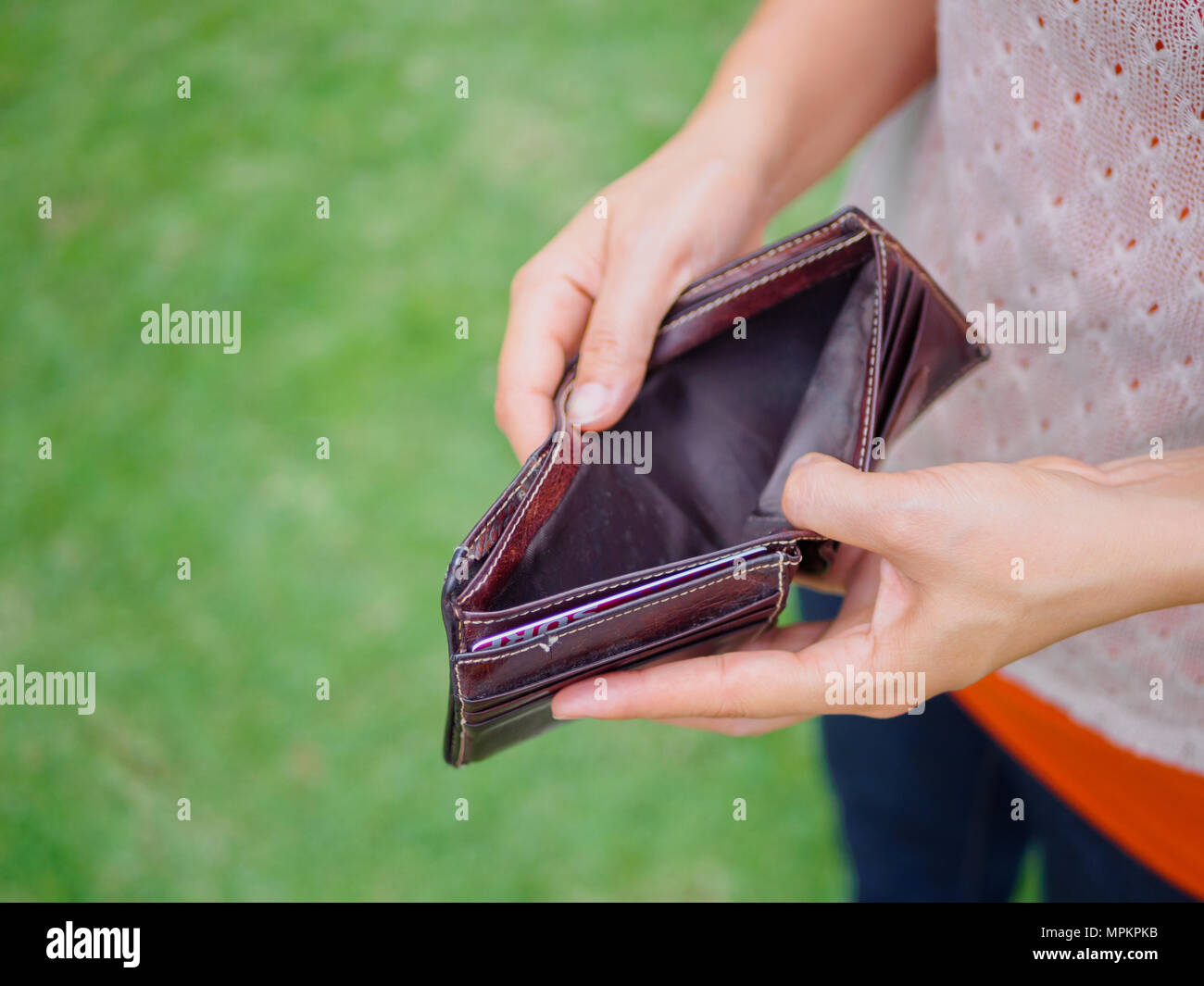 Unhappy bankrupt woman with empty wallet. Young woman shows her empty ...