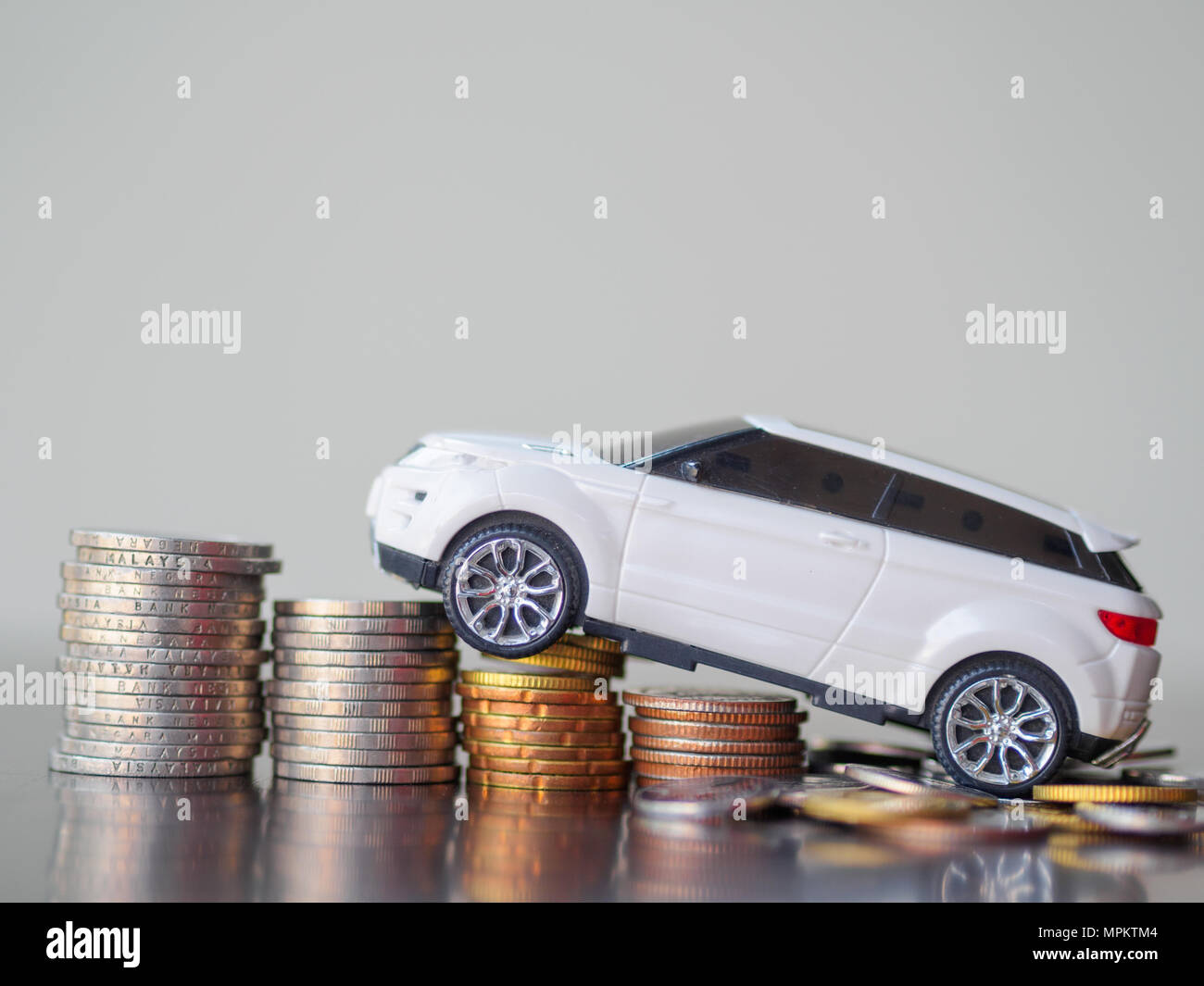 car model on stack of coins Stock Photo - Alamy