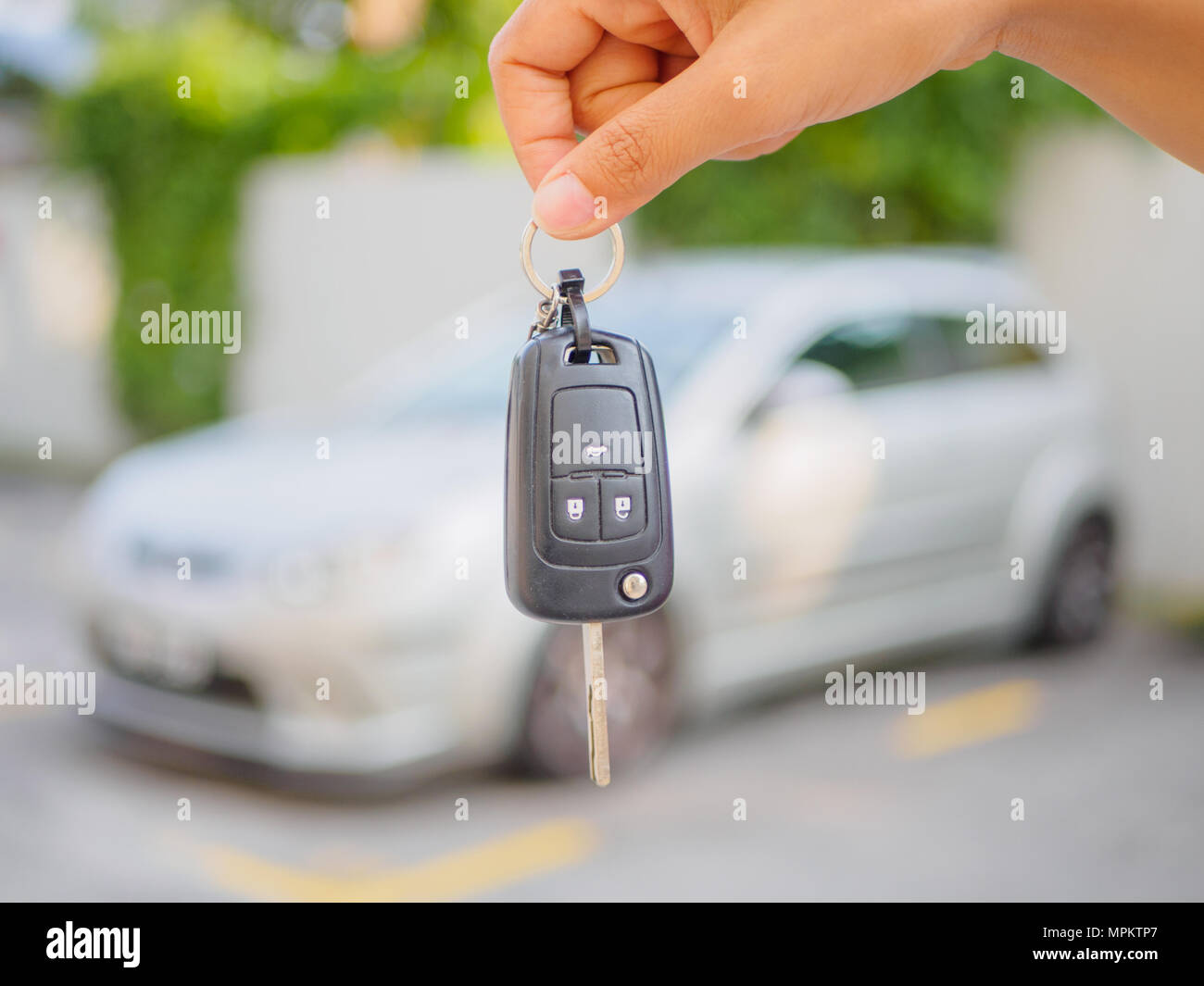 hand presses on the remote control car alarm systems Stock Photo - Alamy