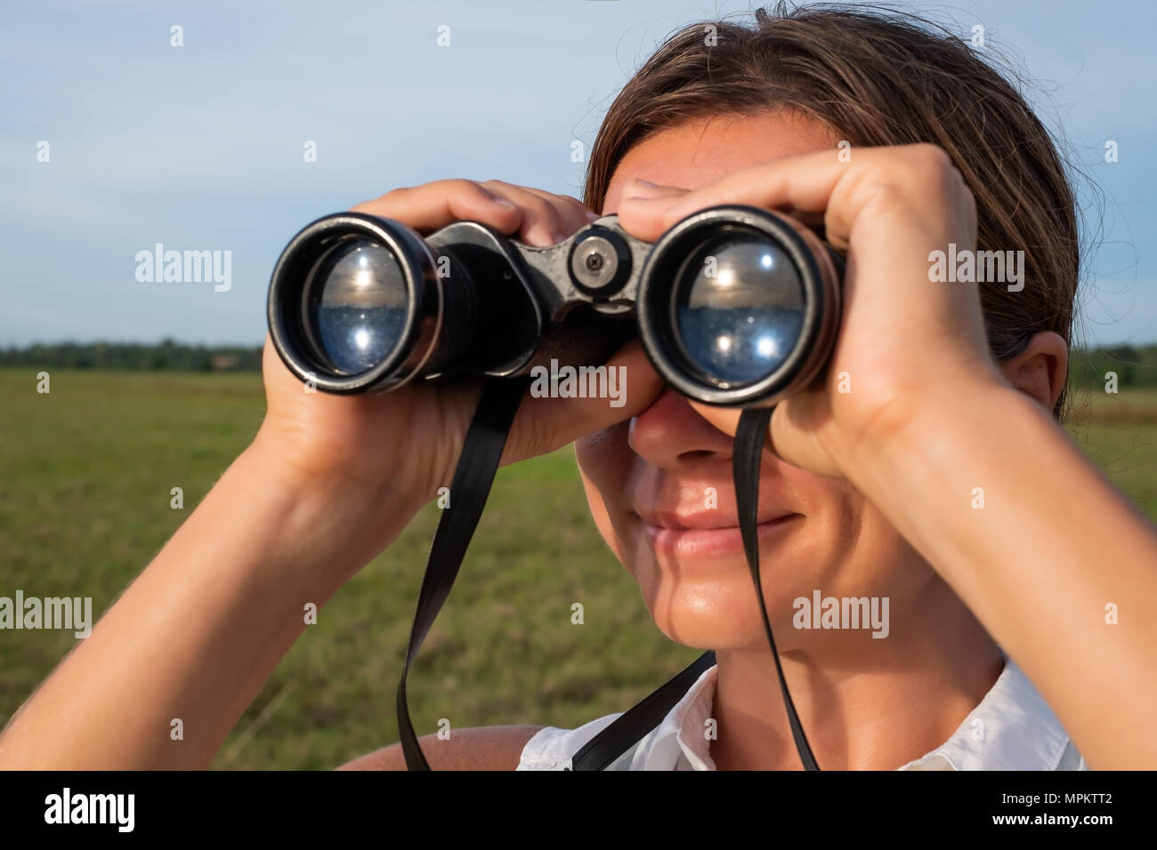Woman holding binocular hi-res stock photography and images - Alamy