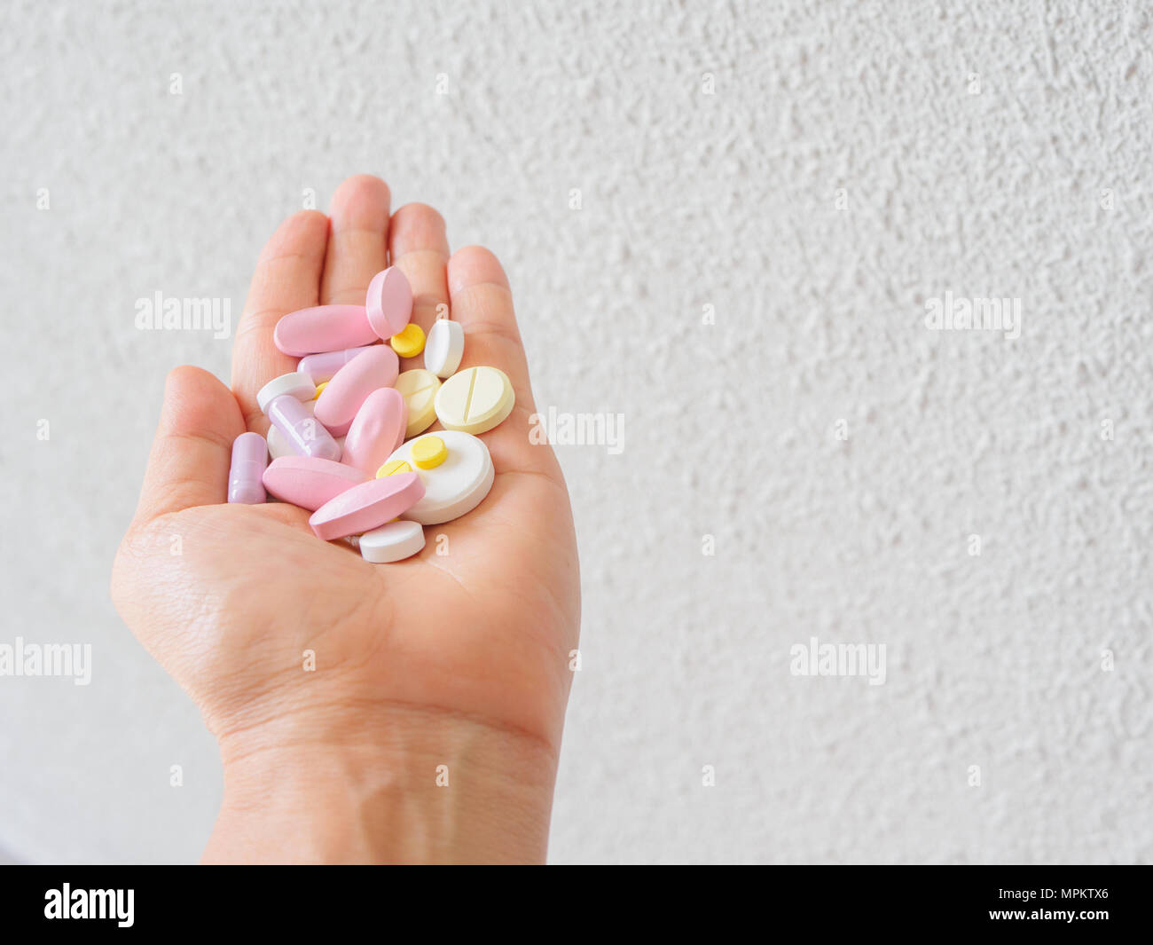 Medicine pills or capsules in hand, palm or fingers. Drug prescription ...