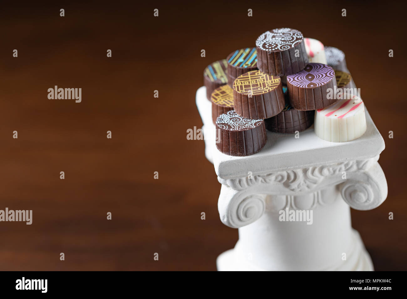 Stack of Fine Artisan Chocolates Stacked On White Pillar Column Stock ...
