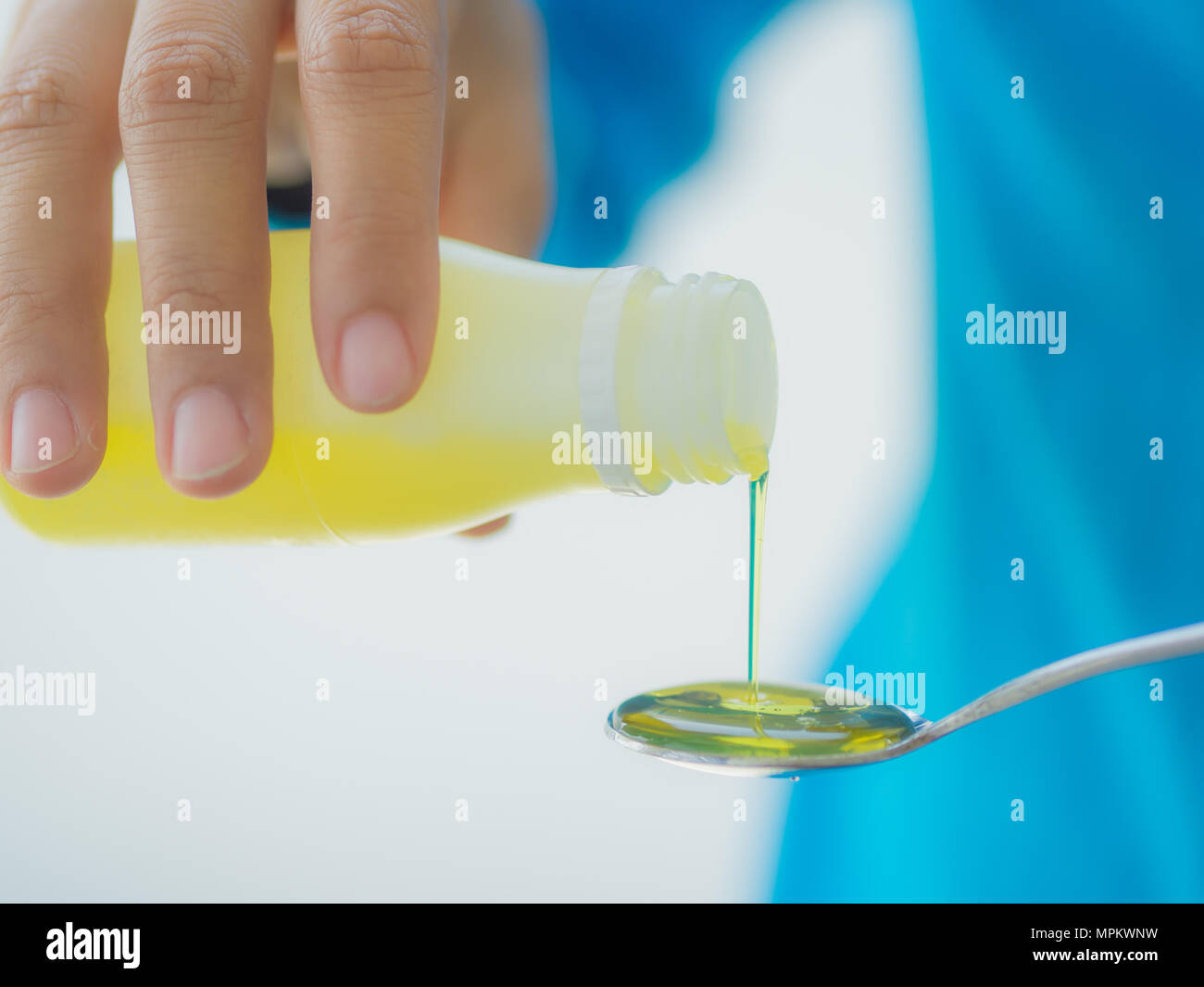 healthcare, people and medicine concept - woman pouring medication or ...