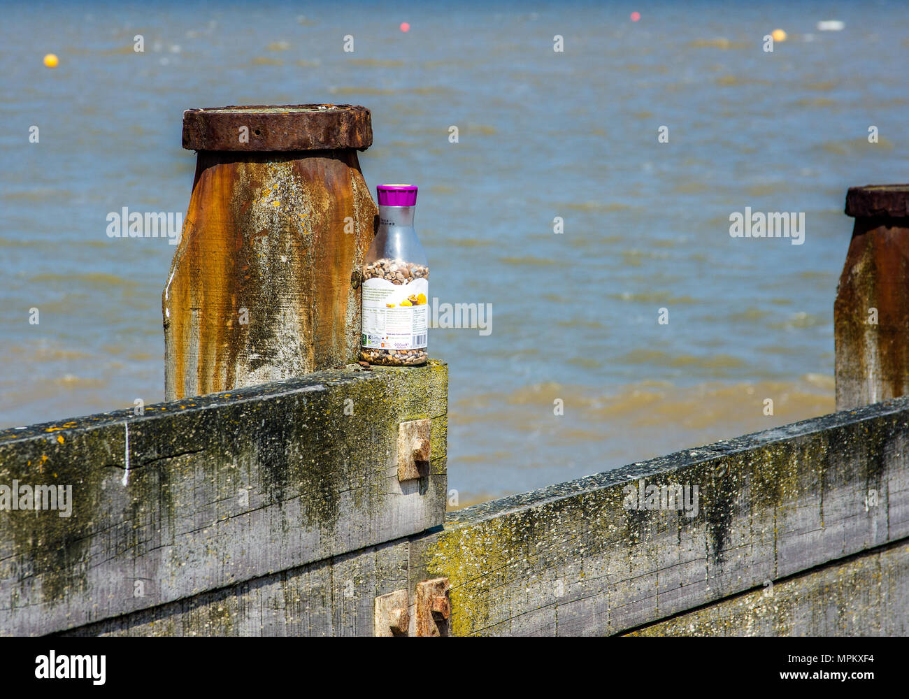 A Plastic Bottle abandoned on a Breakwater Stock Photo - Alamy