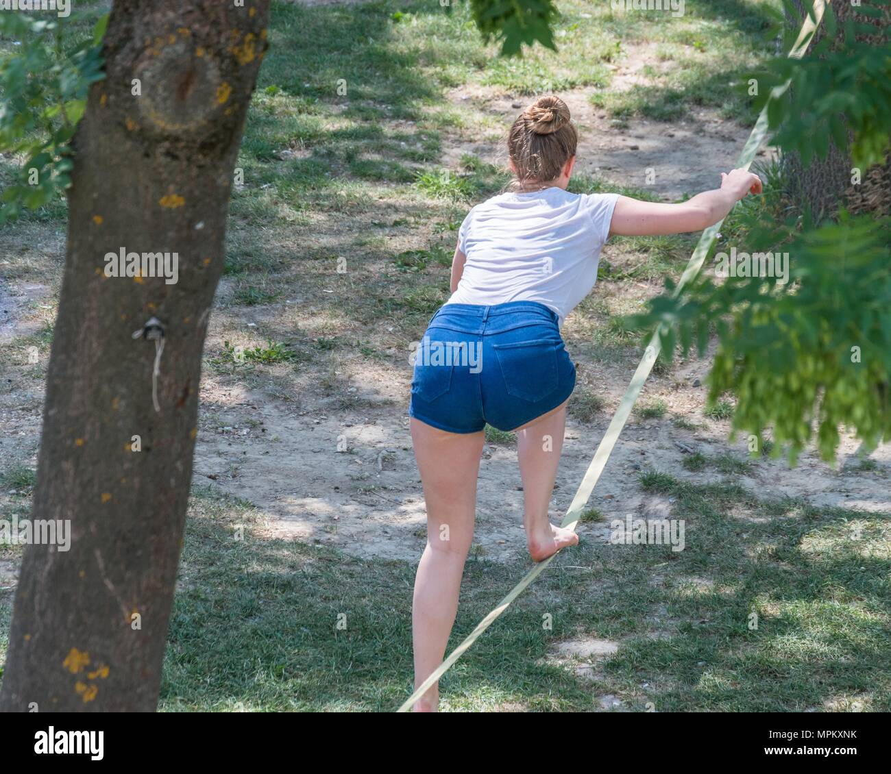 A woman balancing on a slag line, Germany Stock Photo - Alamy