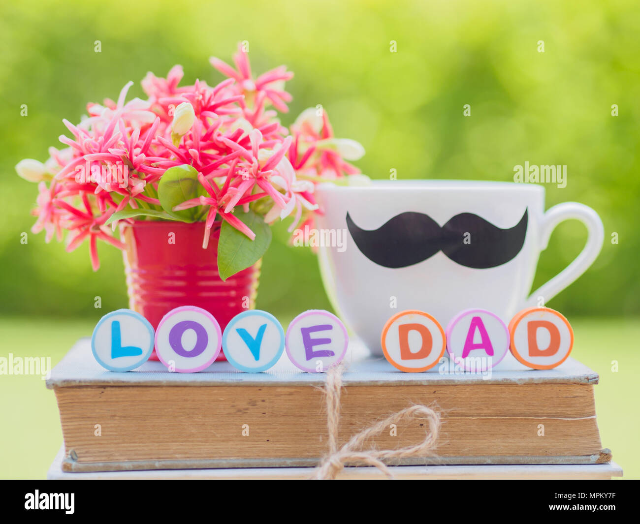 Father's day concept. LOVE DAD alphabet on stack of books, gifts, tea ...