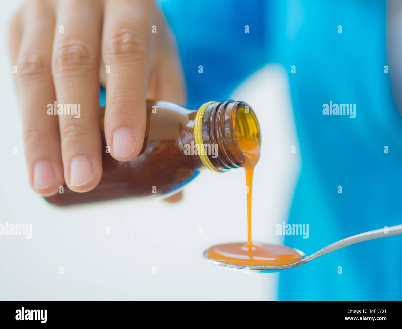 healthcare, people and medicine concept - woman pouring medication or ...