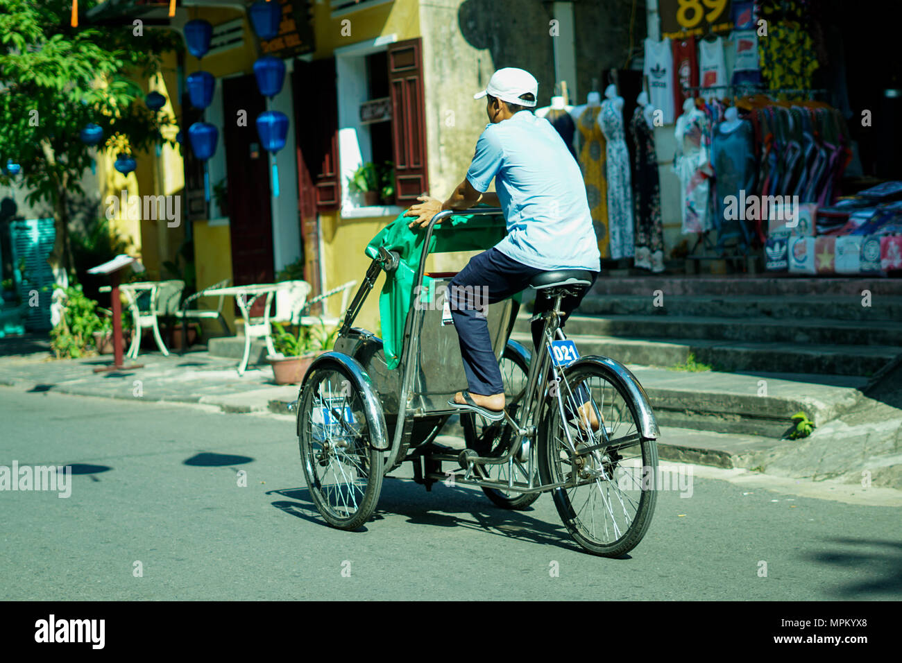 The cyclos in Hoi An old town. Stock photo of cyclo on street, cyclo is ...