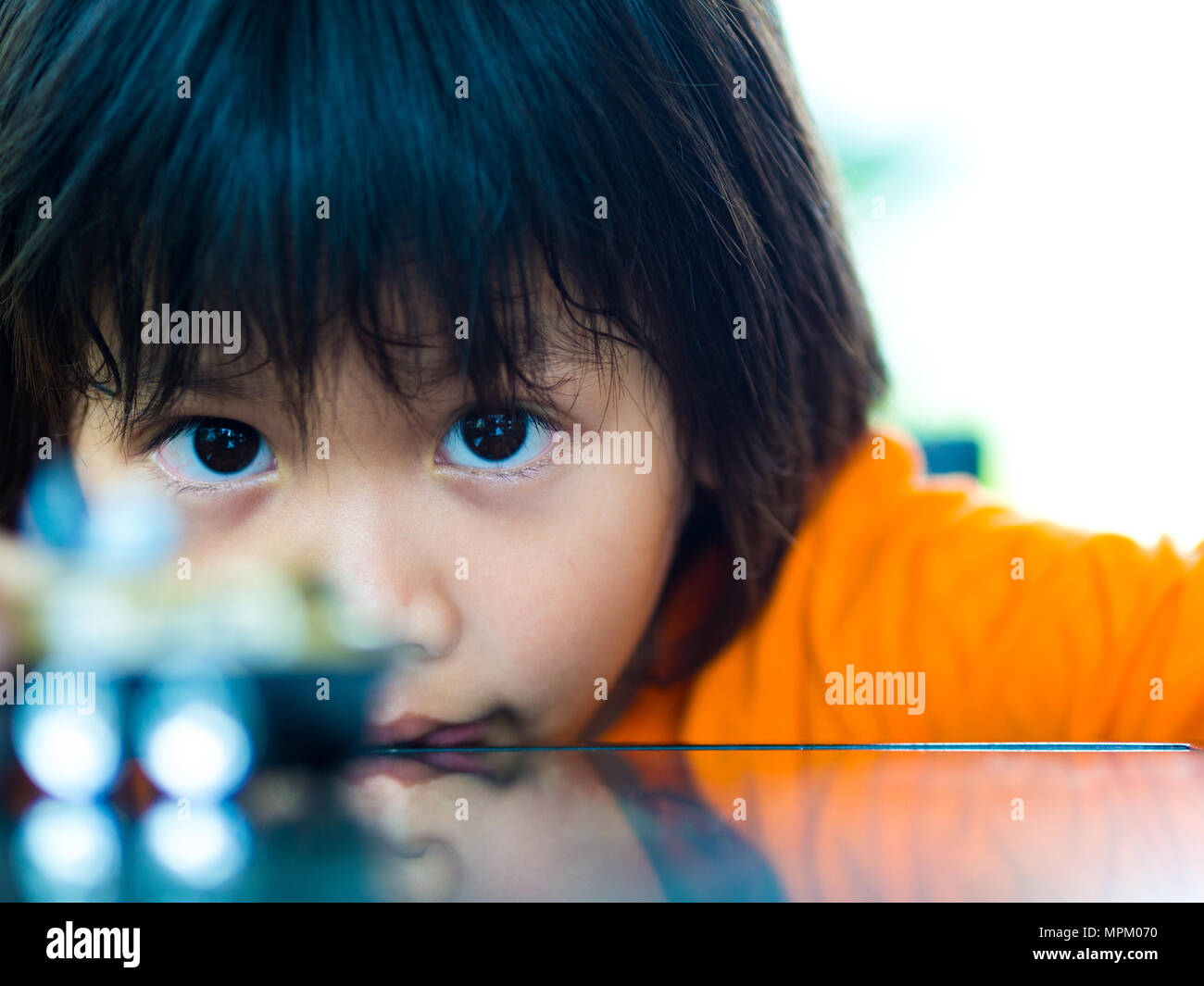 closeup Portrait of a kid look at his toy Stock Photo - Alamy