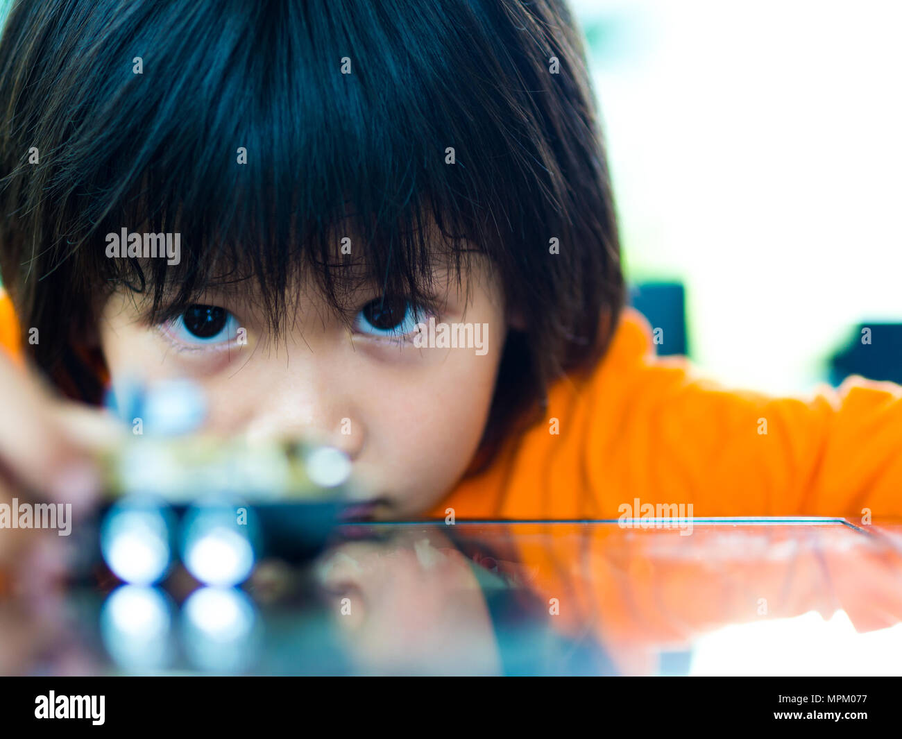 closeup Portrait of a kid look at his toy Stock Photo - Alamy