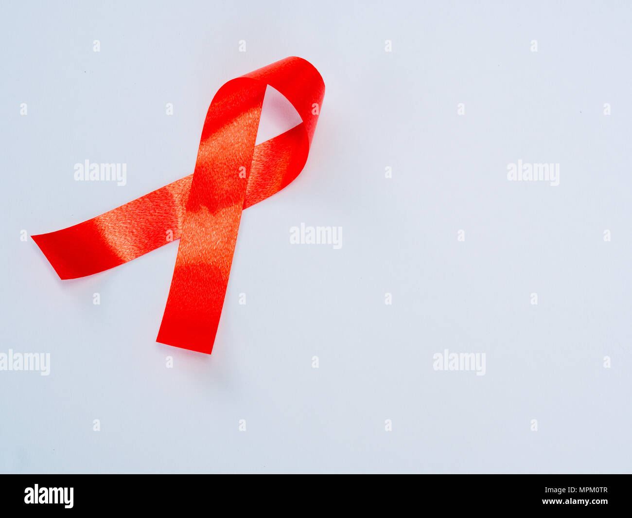 World AIDS day concept. red ribbon on white paper Stock Photo - Alamy