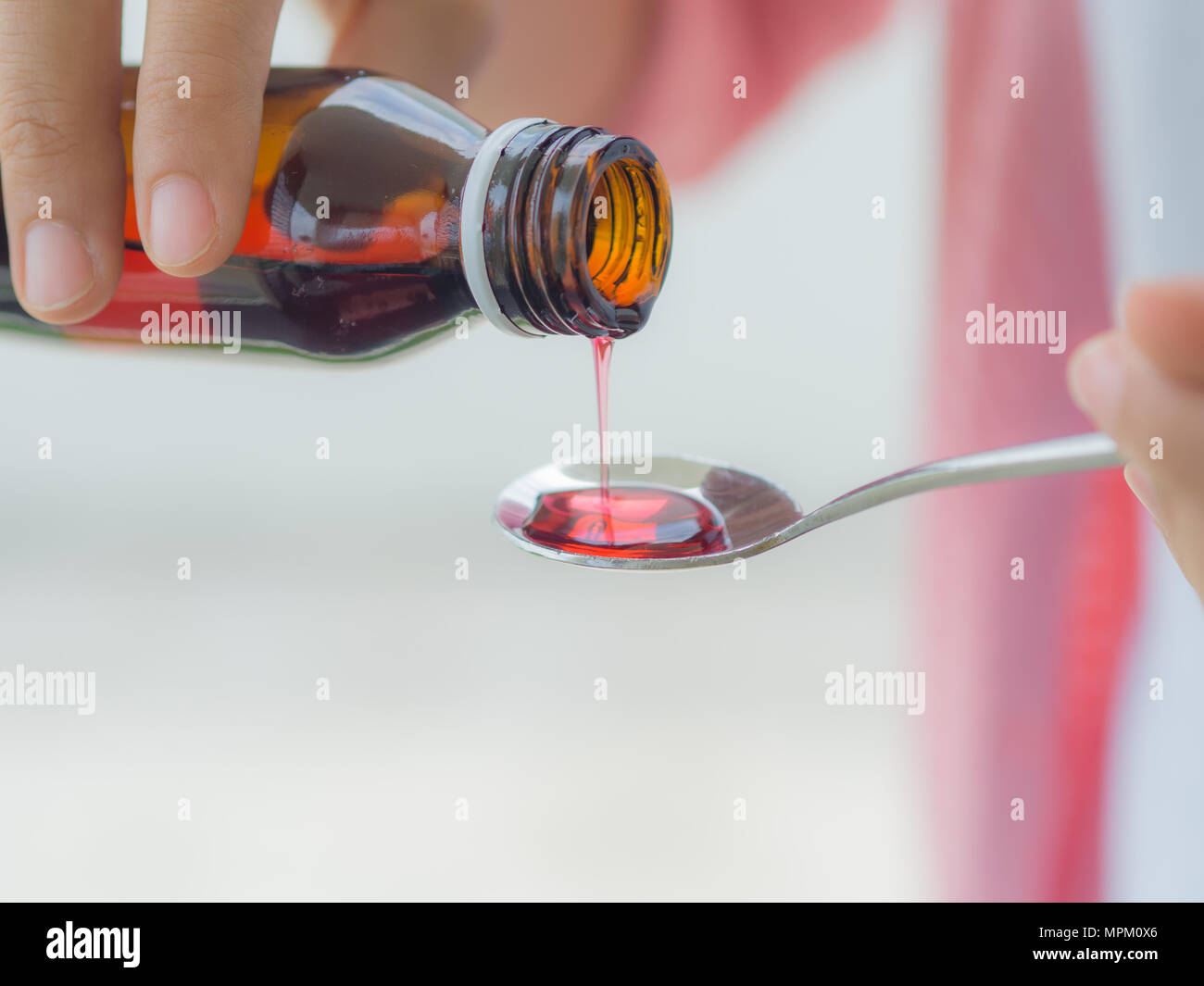 healthcare, people and medicine concept - woman pouring medication or ...