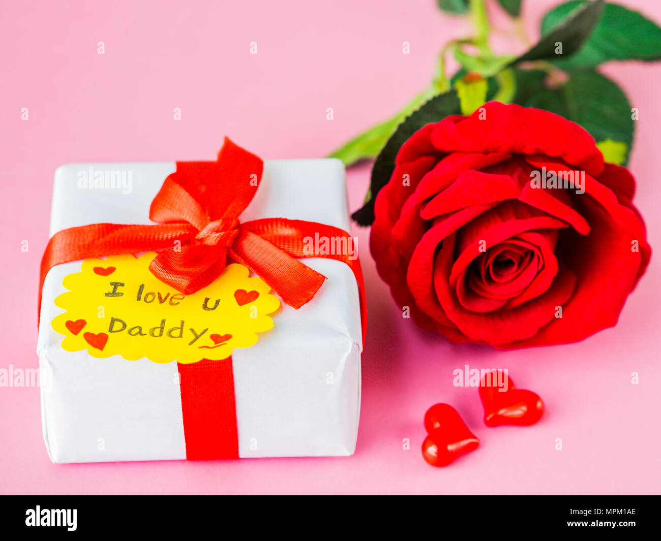 Father's day concept. I LOVE YOU DADY message with red rose, two red ...
