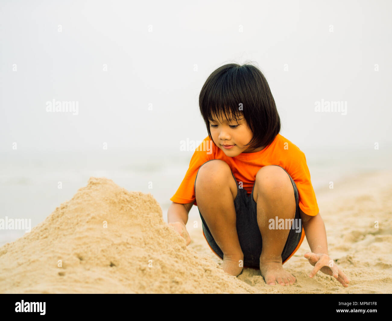 Boy making sandcastles hi-res stock photography and images - Alamy