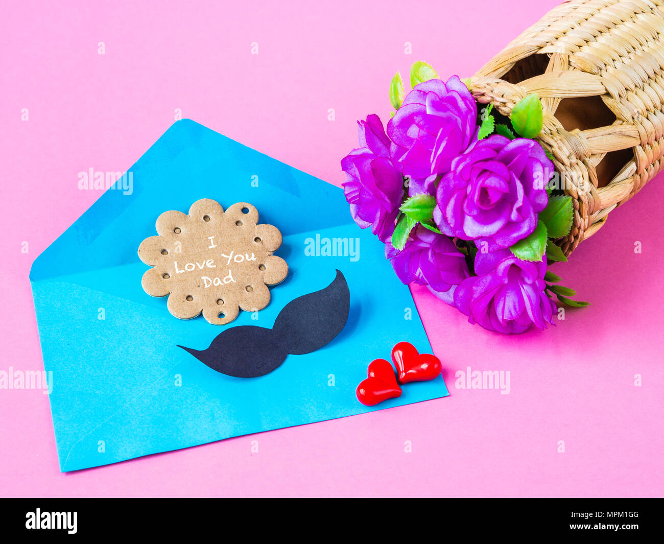 Father's day concept. I LOVE YOU DAD message with pink flower, two red ...