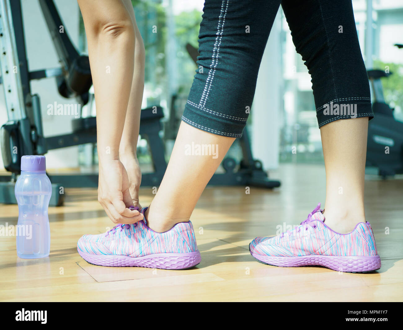 Woman tying gym shoe laces hi-res stock photography and images - Alamy