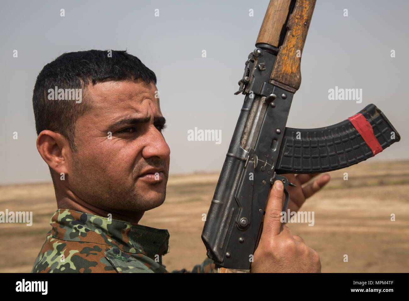 An Iraqi security forces soldier listens to instructions during short ...