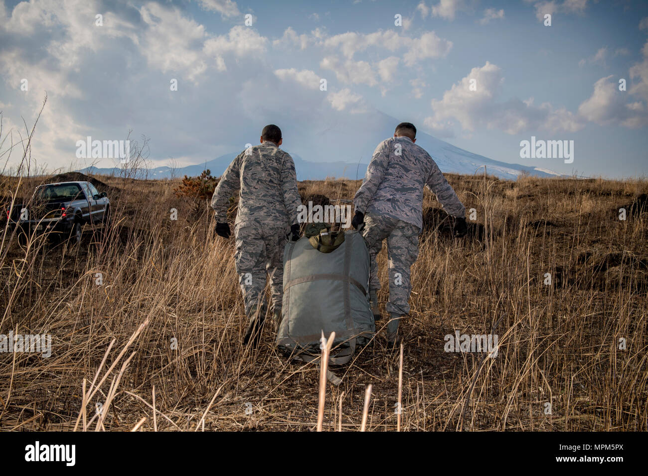 Airmen from the 374th Logistics Readiness Squadron carry a repacked ...