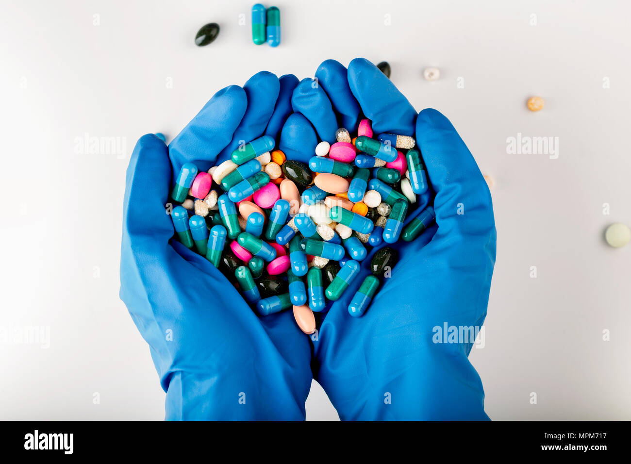 Hands full of medication with different types and colours. Medical ...