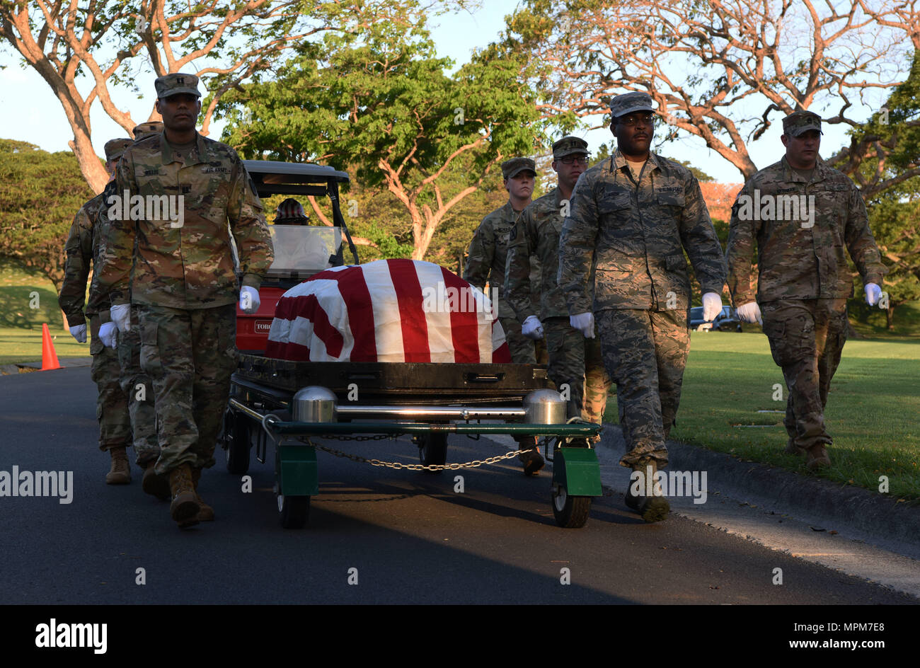 DPAA personnel transport a casket during a disinterment ceremony at the ...