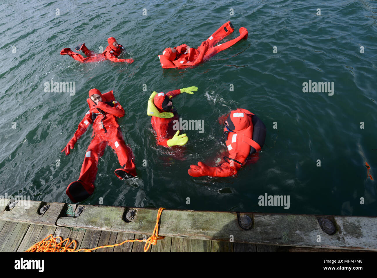 Mike Rudolph (yellow gloves), a fishing vessel safety examiner from the ...