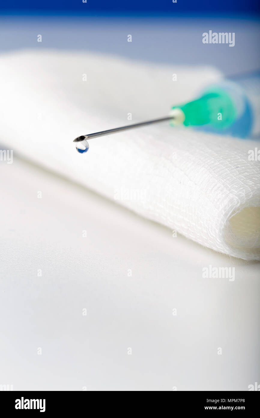 Syringe on gauze with water on top of needle Stock Photo - Alamy