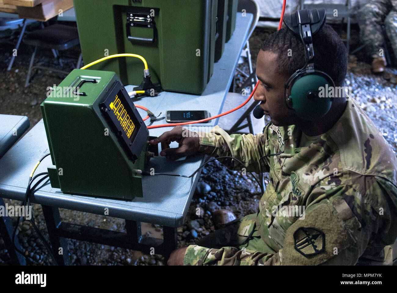 Sgt. Kenneth G. Elliott programs a Crew Access Unit (CAU) inside the ...